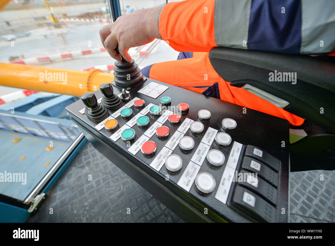 Crane operator Martin Redmond toggles the joysick inside his cab on ...