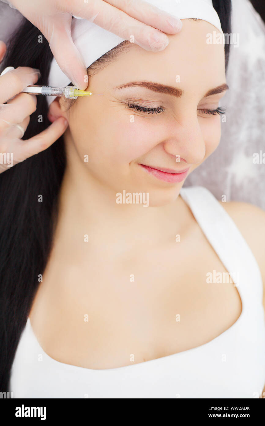 Beautiful woman gets injections. Cosmetology. Beauty Face Stock Photo ...