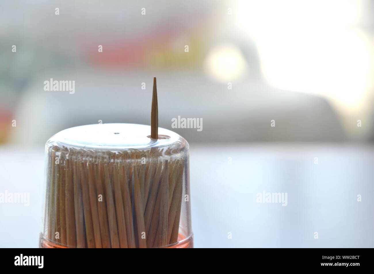 single toothpick out from container hole Stock Photo - Alamy