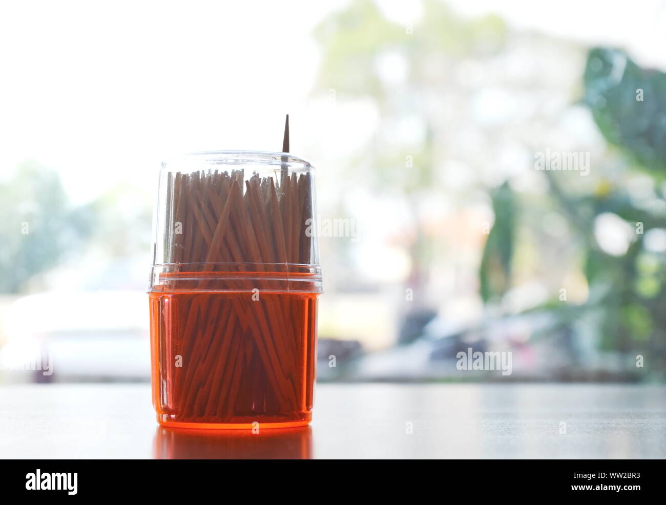 single toothpick out from container hole Stock Photo - Alamy