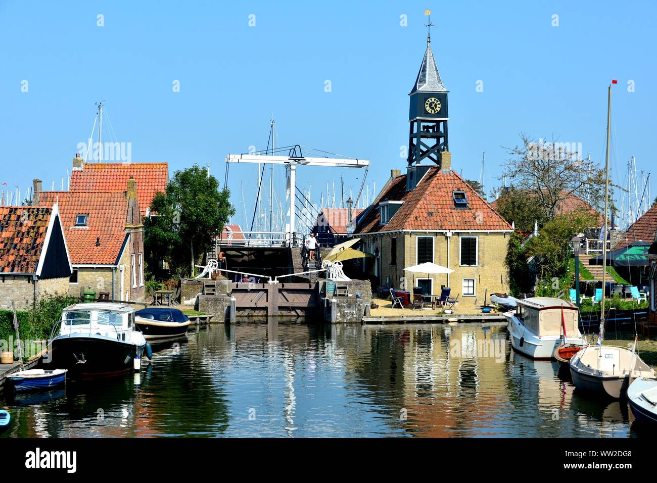 Motor boats in a small canal at the sluice house in Hindeloopen ...
