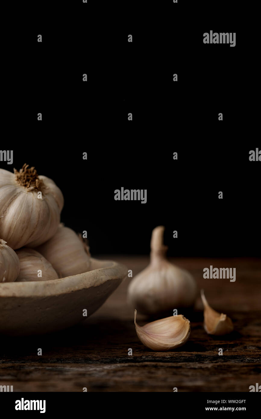 Still life of garlic bulb in dark black background with copy space, It ...