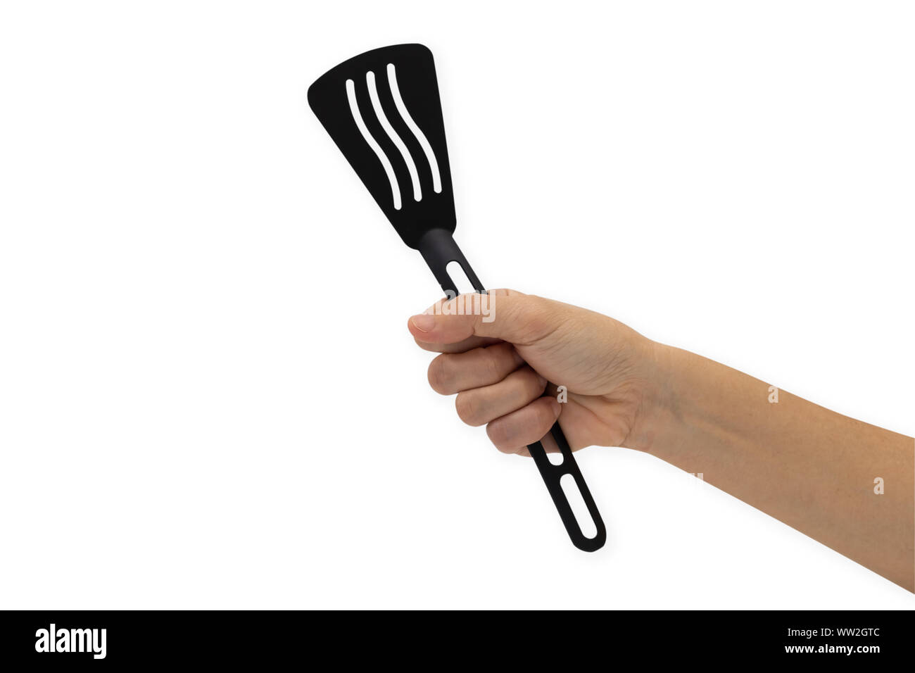 Hand holding a spatula isolated on a white background Stock Photo - Alamy