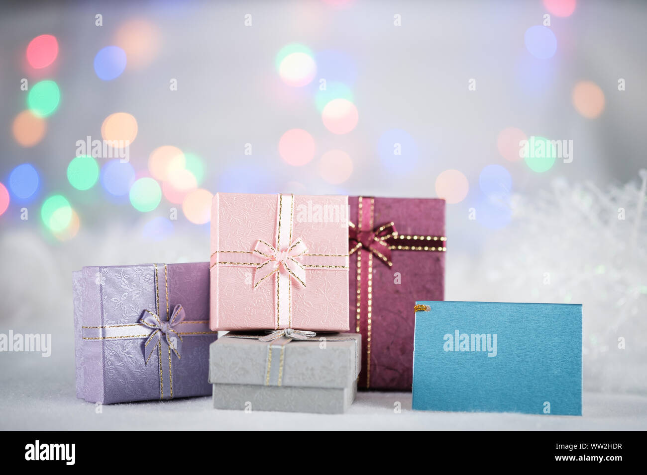 Colorful gift boxes on the white fur on bokeh background, with copy ...