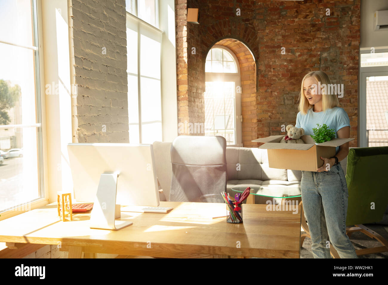 A young businesswoman moving in the office, getting new work place ...