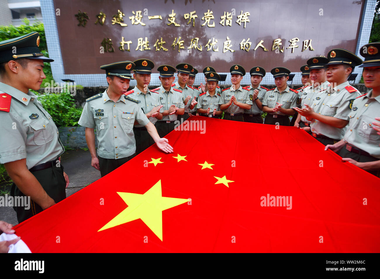 Chinese paramilitary policemen of the local armed police force holds a ...