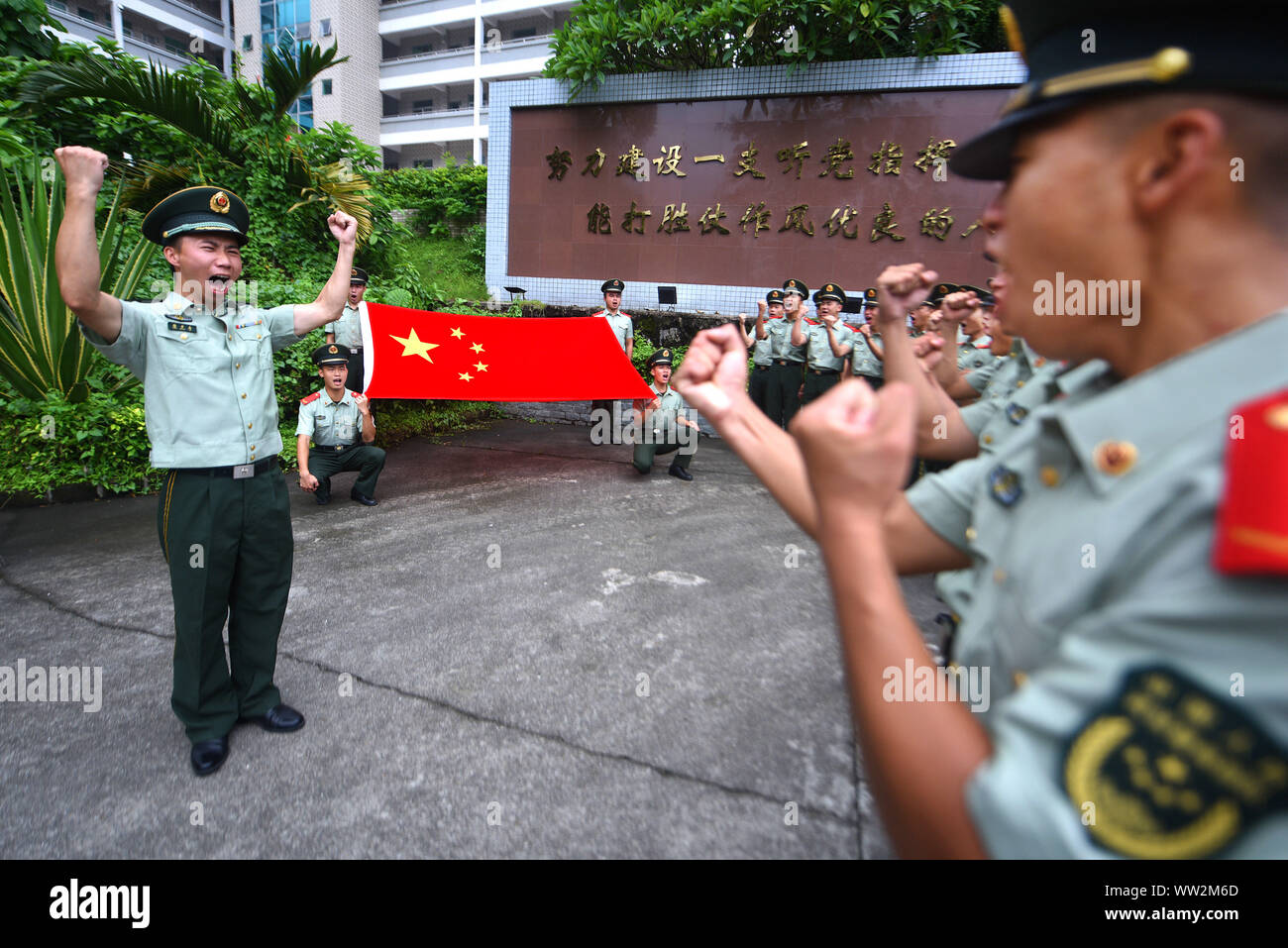 Chinese paramilitary policemen of the local armed police force sing ...