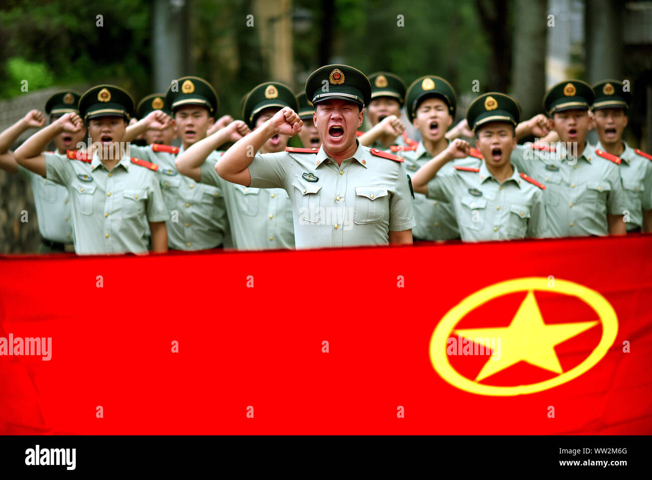 Chinese paramilitary policemen of the local armed police force shout ...