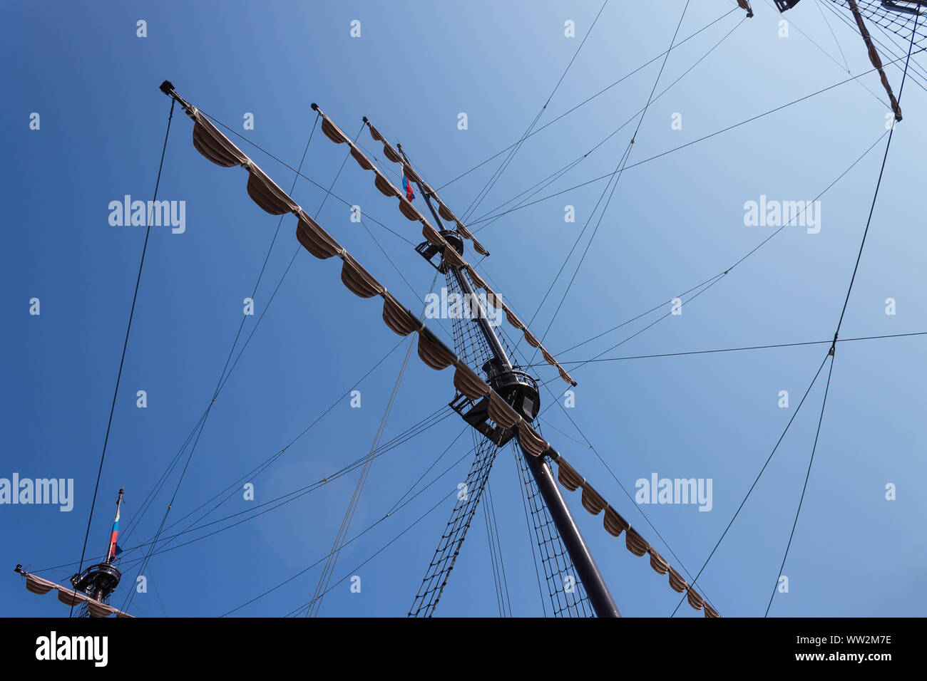 Mast of an old ship with raised sails against a clear blue sky Stock ...