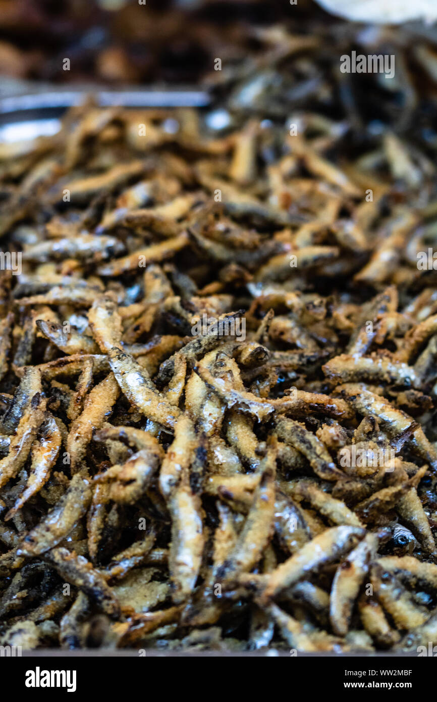 Fried little fish in market or food festival, food truck, food market ...