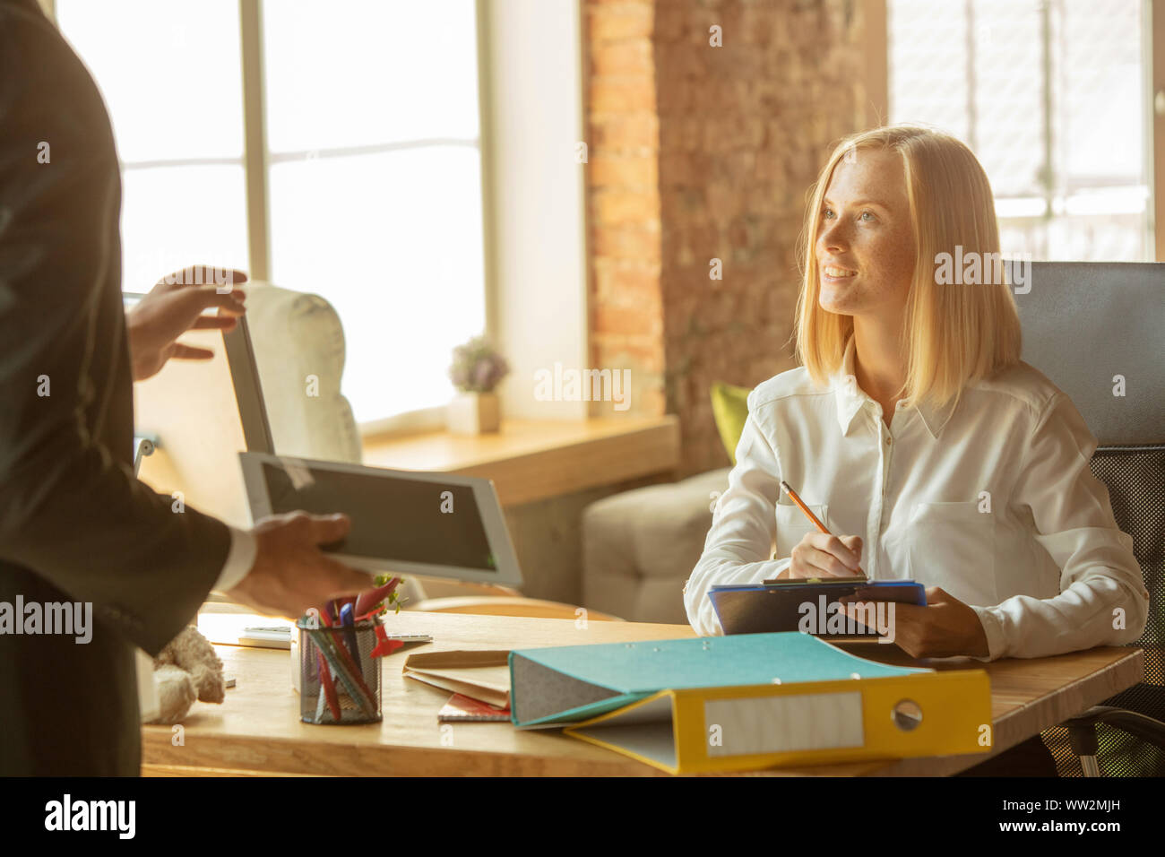 A young businesswoman moving in the office, getting new work place ...