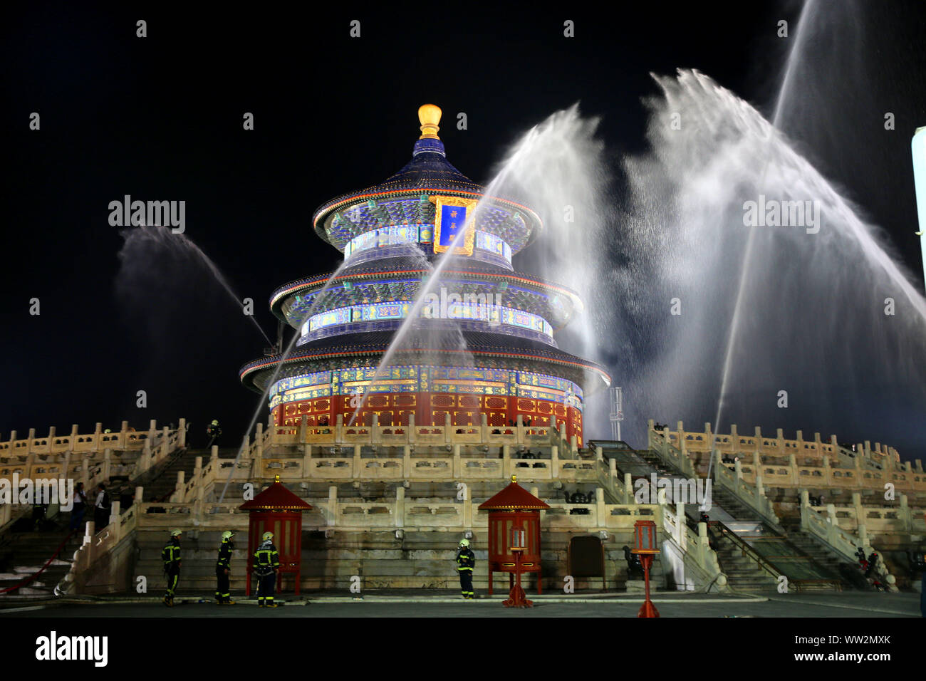 Chinese firemen hose water onto the Hall of Prayer for Good Harvest ...
