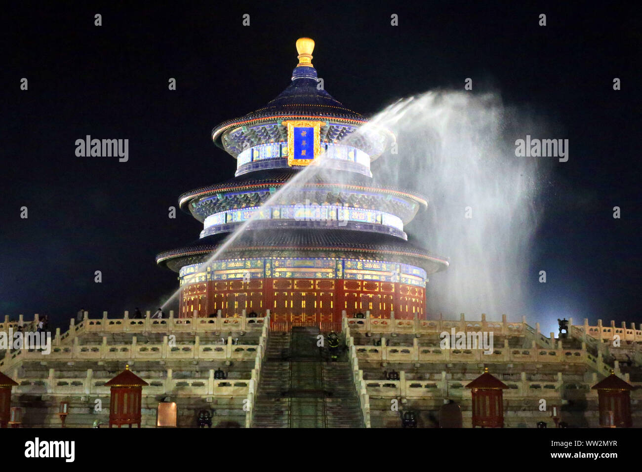 Chinese firemen hose water onto the Hall of Prayer for Good Harvest ...
