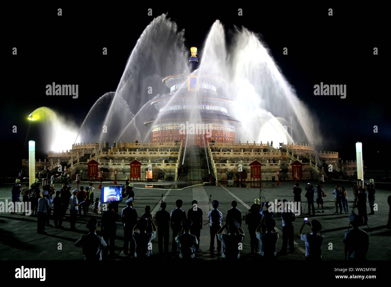 Chinese firemen hose water onto the Hall of Prayer for Good Harvest ...