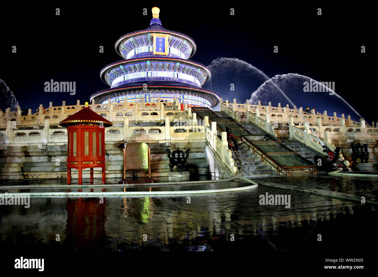 Chinese firemen hose water onto the Hall of Prayer for Good Harvest ...