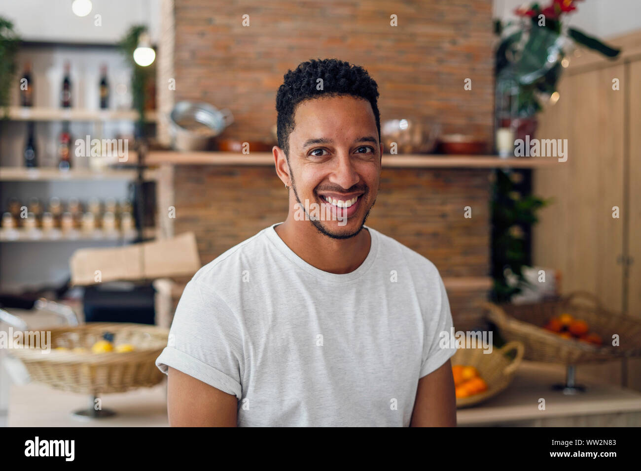 Portrait of man sitting in shop Stock Photo - Alamy