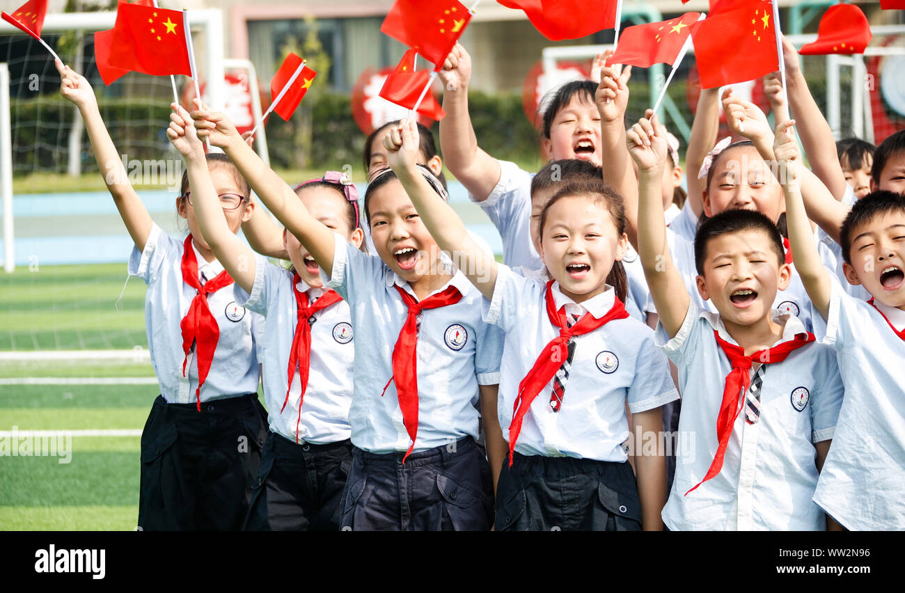 Young Chinese students wave Chinese national flags during a celebration ...