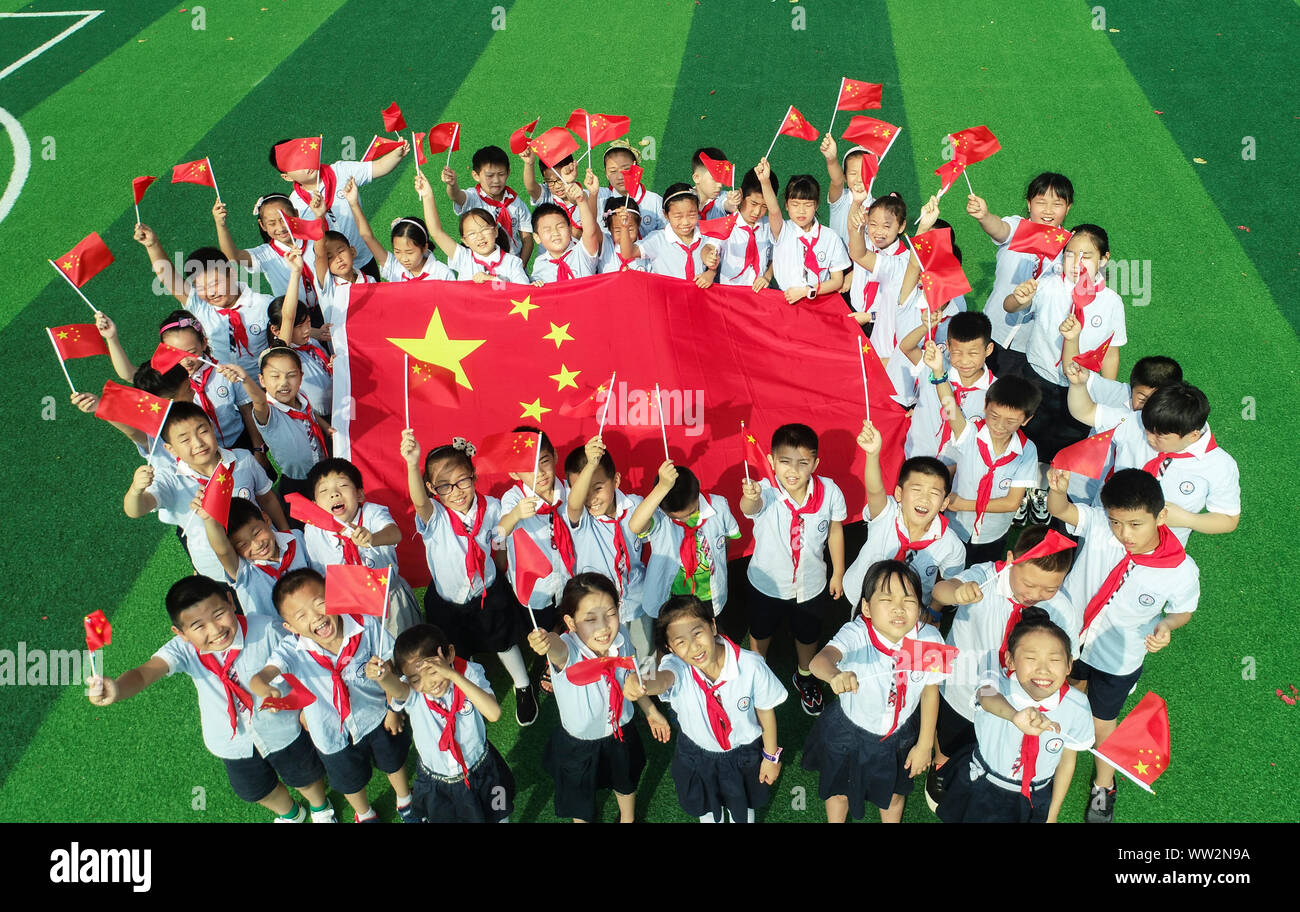 Young Chinese students wave Chinese national flags during a celebration ...