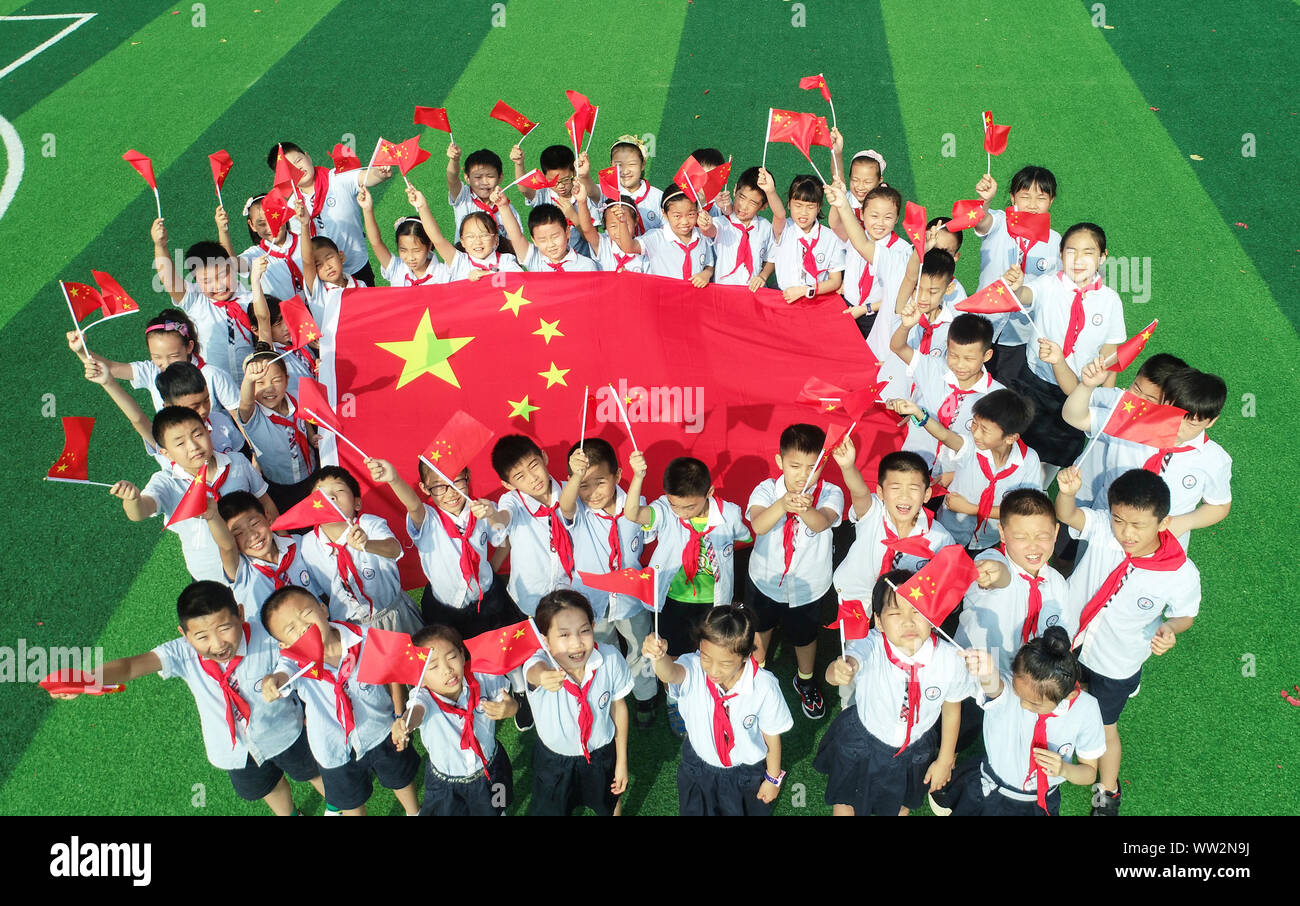 Young Chinese students wave Chinese national flags during a celebration ...