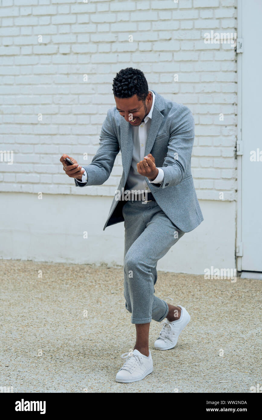 Excited male standing mobile phone hi-res stock photography and images ...