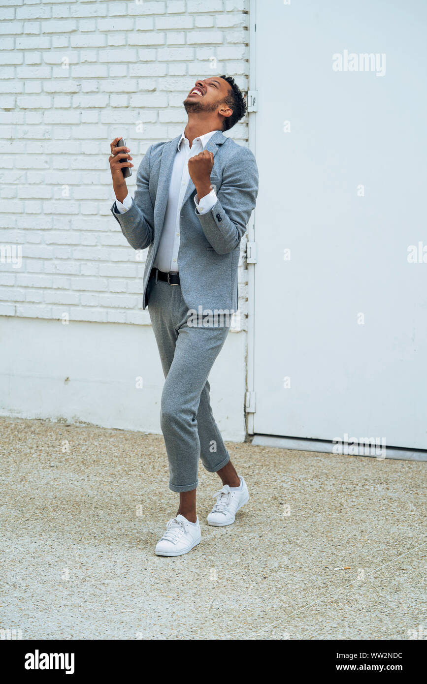 Excited male standing mobile phone hi-res stock photography and images ...