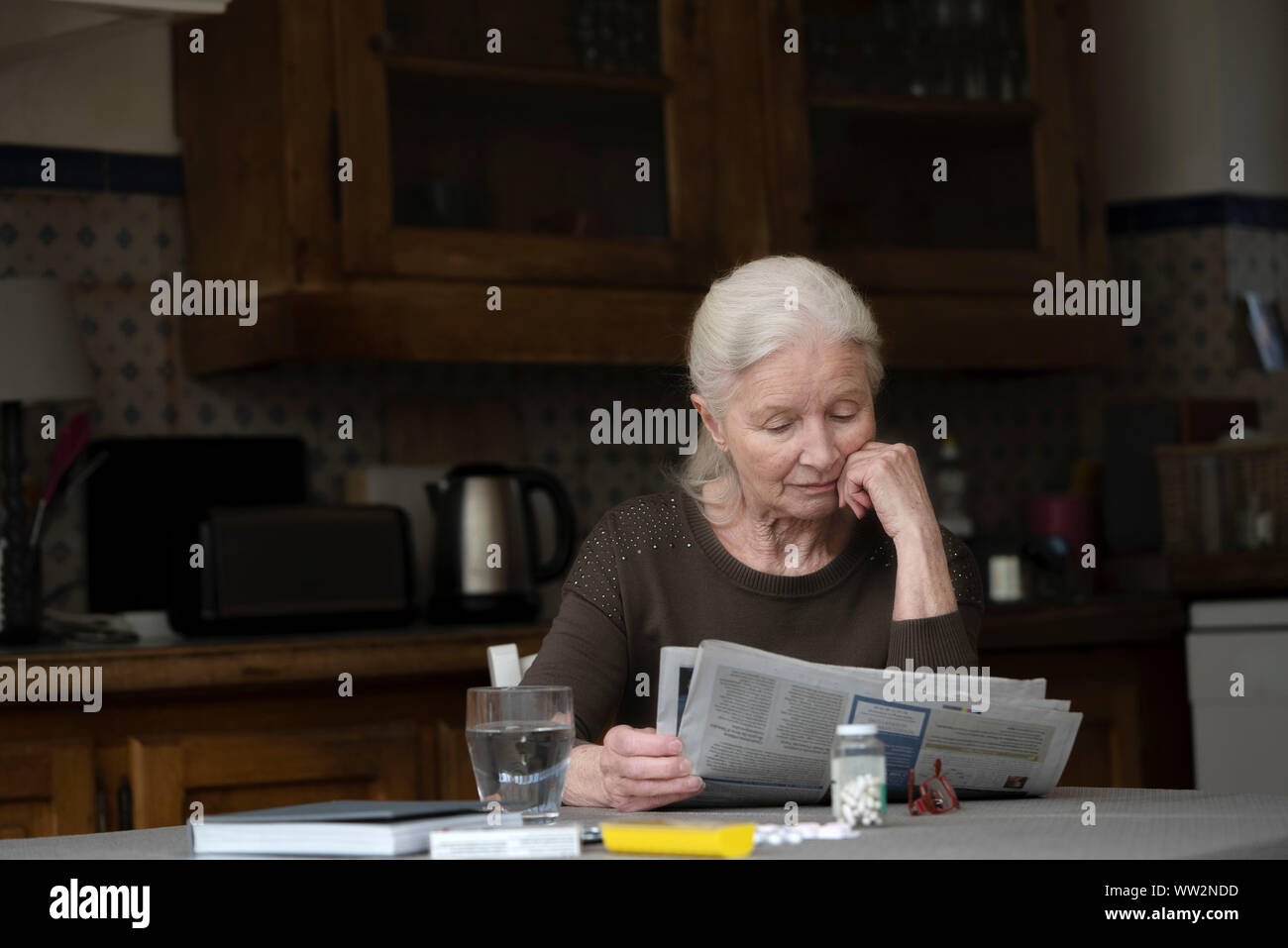Senior woman reading newspaper Stock Photo - Alamy