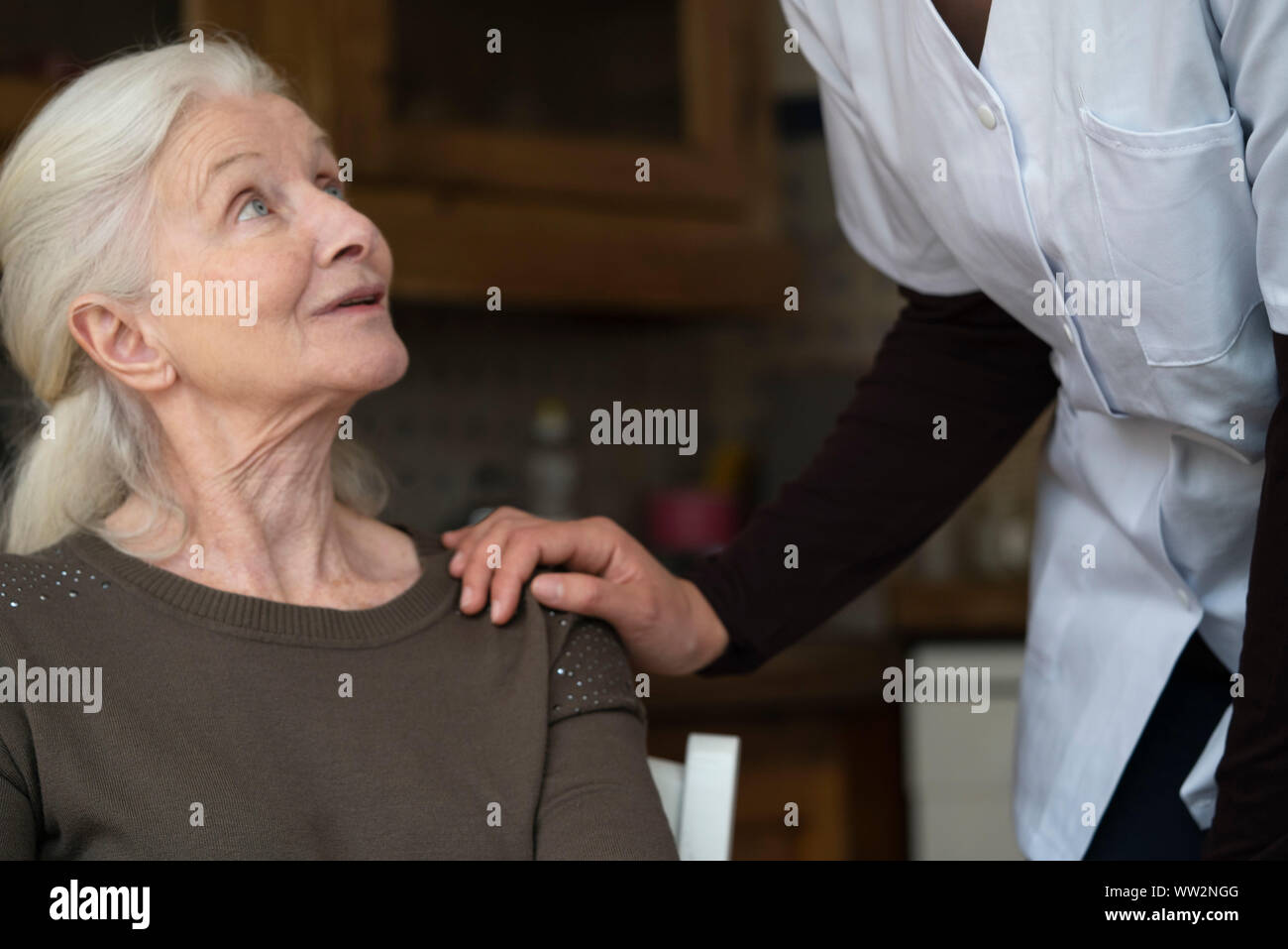 Nurse consoling woman Stock Photo - Alamy