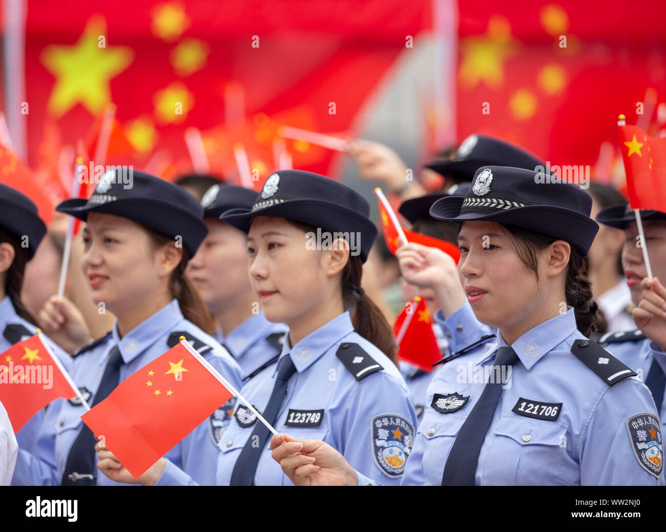 Chinese policewomen wave Chinese national flags during a campaign to ...