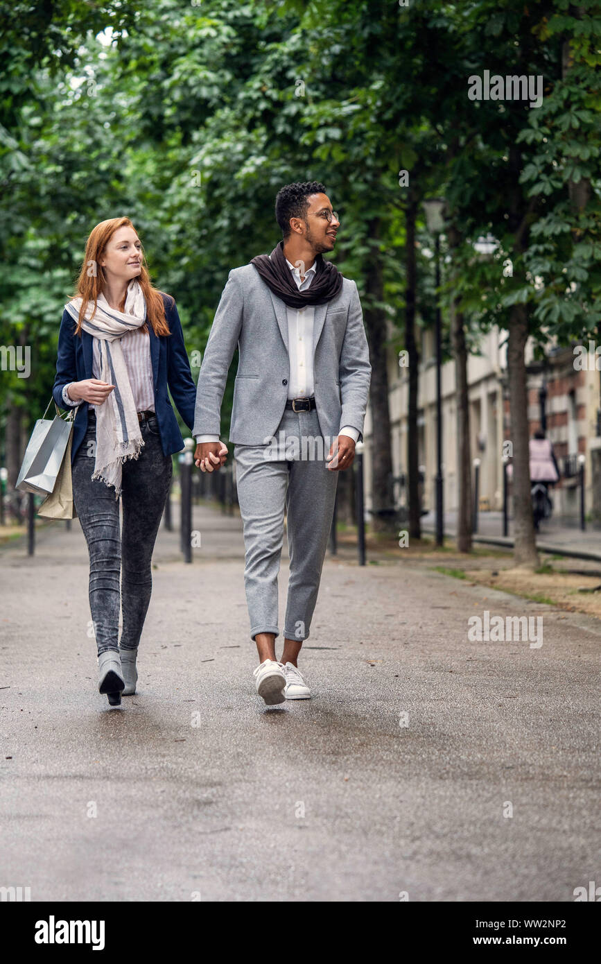 Couple walking on street Stock Photo - Alamy