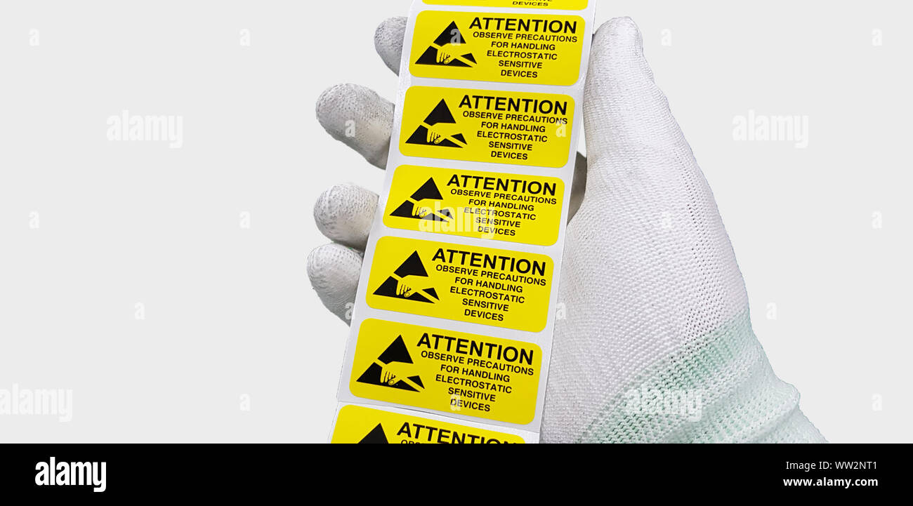 Hand holding ESD symbol label with antistatic gloves on static free ...
