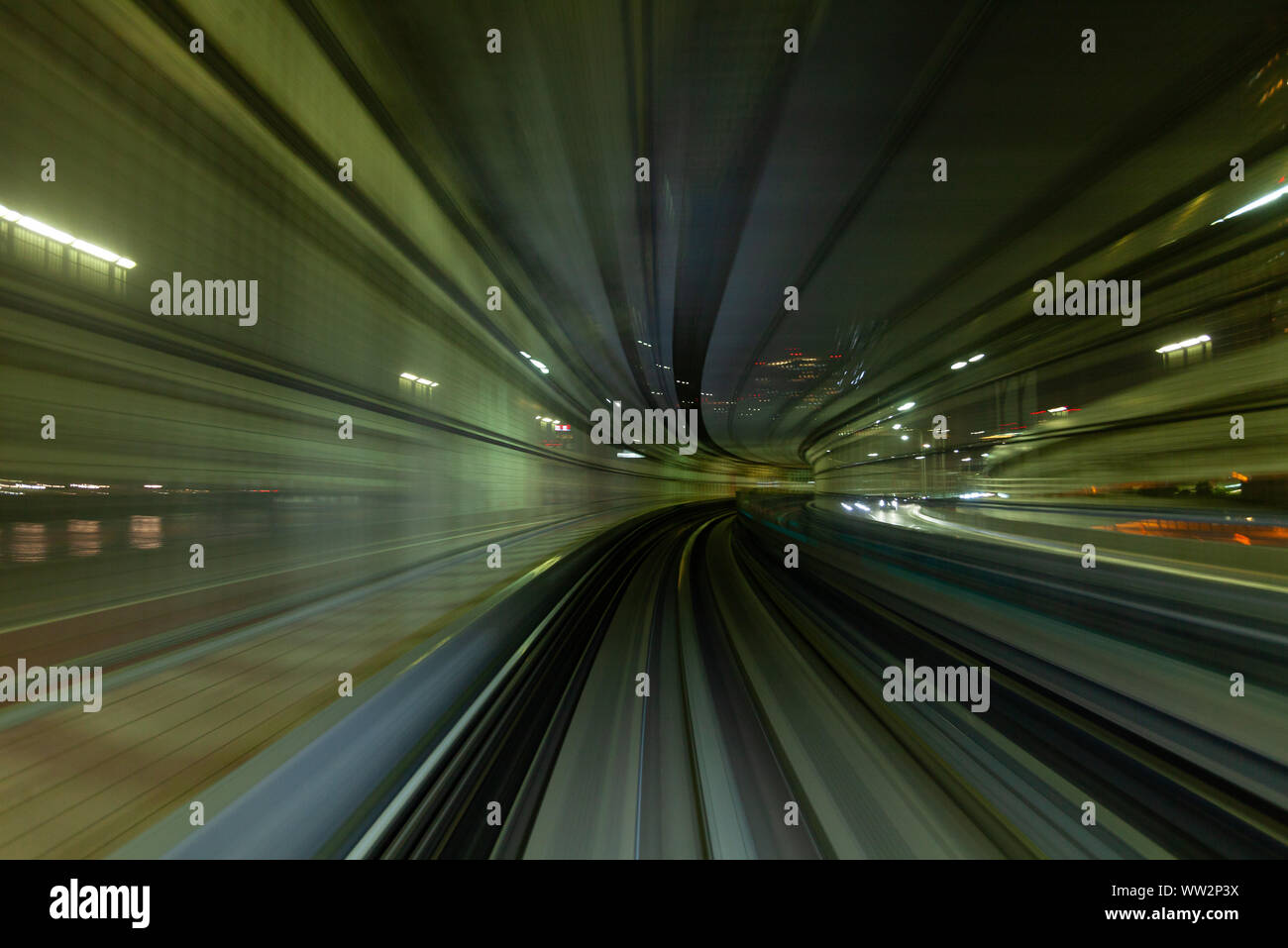 High speed train moving in city Stock Photo - Alamy
