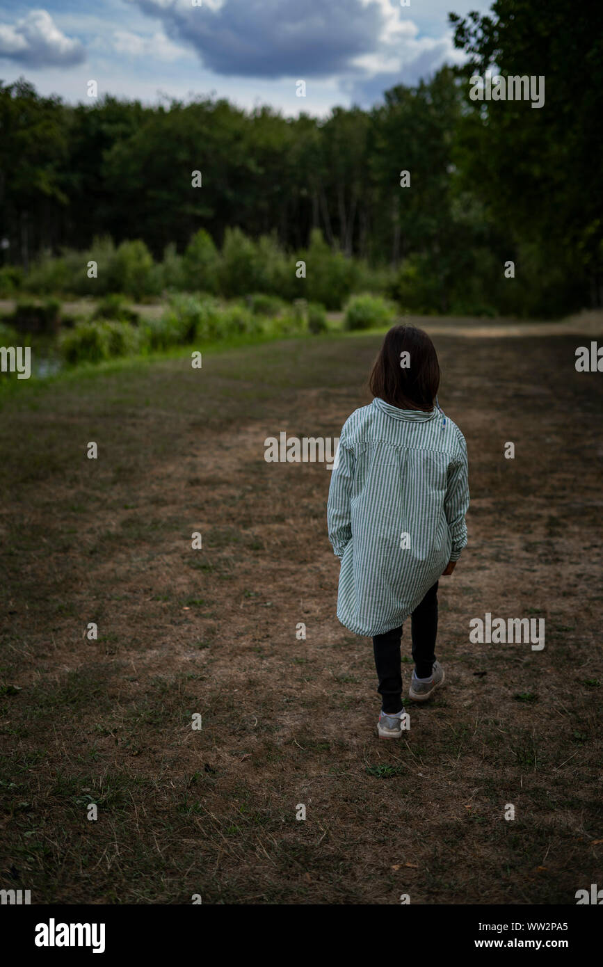 Girl walking outdoors Stock Photo - Alamy