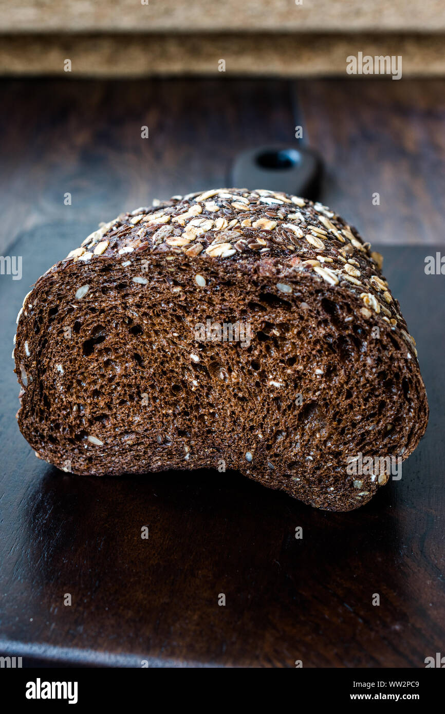 Malt Bread Slices with Oat and Flax Seeds on Dark Wooden Board. Organic ...