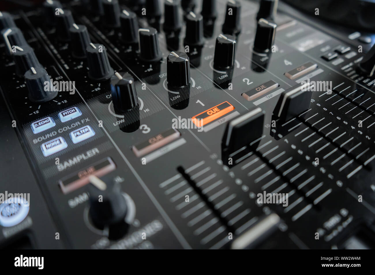 Wide angle photo of black sound mixer controller with knobs and sliders ...