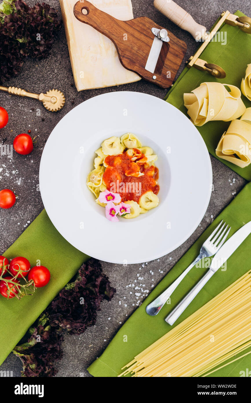 Pasta made of spaghetti on a gray background with decorations for ...