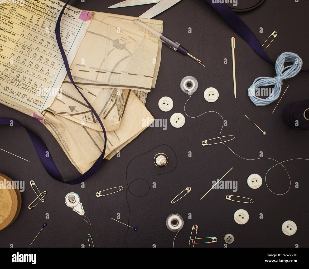 Busy sewing flat lay photo with lots of accessories, tools and ...