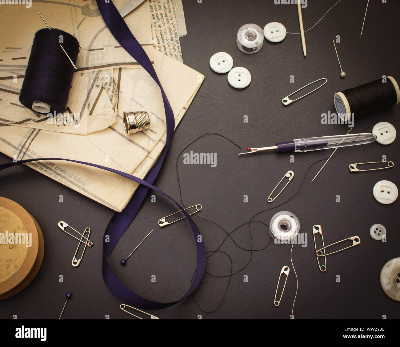 Busy sewing flat lay photo with lots of accessories, tools and ...