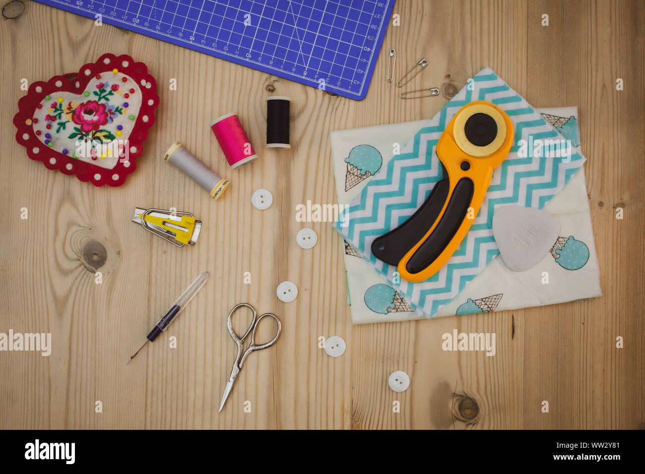 Flat lay image of sewing tools, equipment and accessories on wooden ...