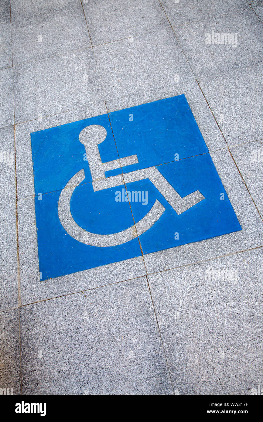 Blue Disabled Symbol on Street Surface Stock Photo - Alamy