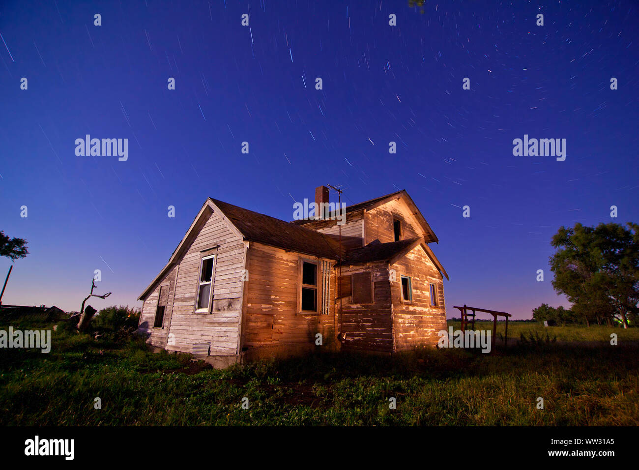 abandoned farmhouse at night with star trails and north star Stock ...