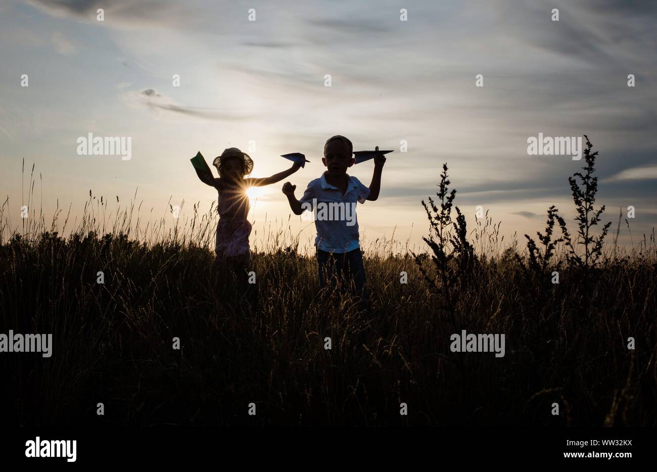 Boy and girl siblings and silhouette hi-res stock photography and ...