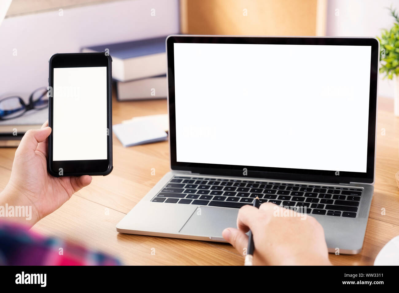Closeup hands using smartphone mockup at the office desk. Blank screen ...