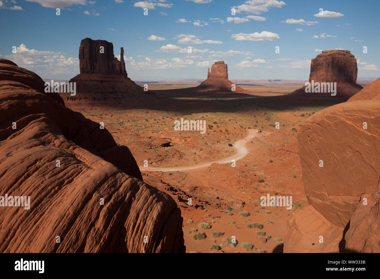 Clouds shade part of the iconic rock formations at Monument Valley, AZ ...