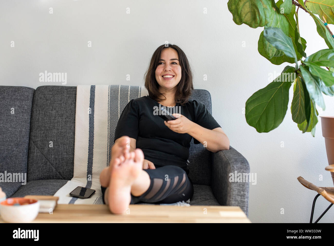 Feet up watching television hi-res stock photography and images - Alamy