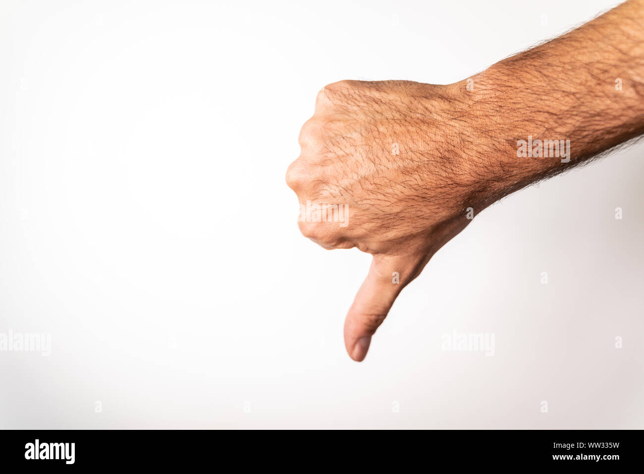 Thumb down hand sign isolated on white Stock Photo - Alamy