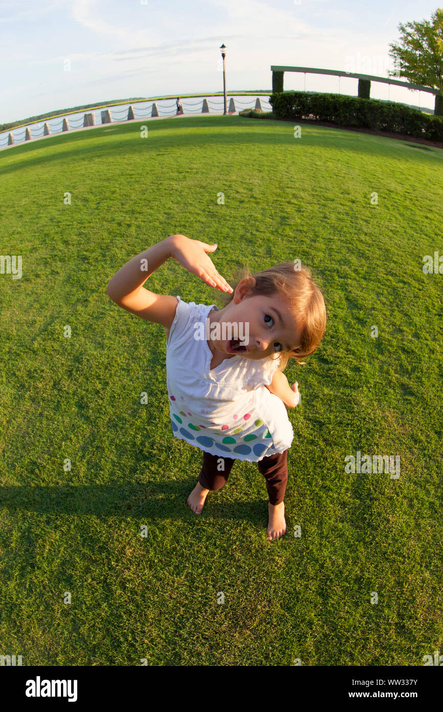 little girl being goofy in park Stock Photo - Alamy