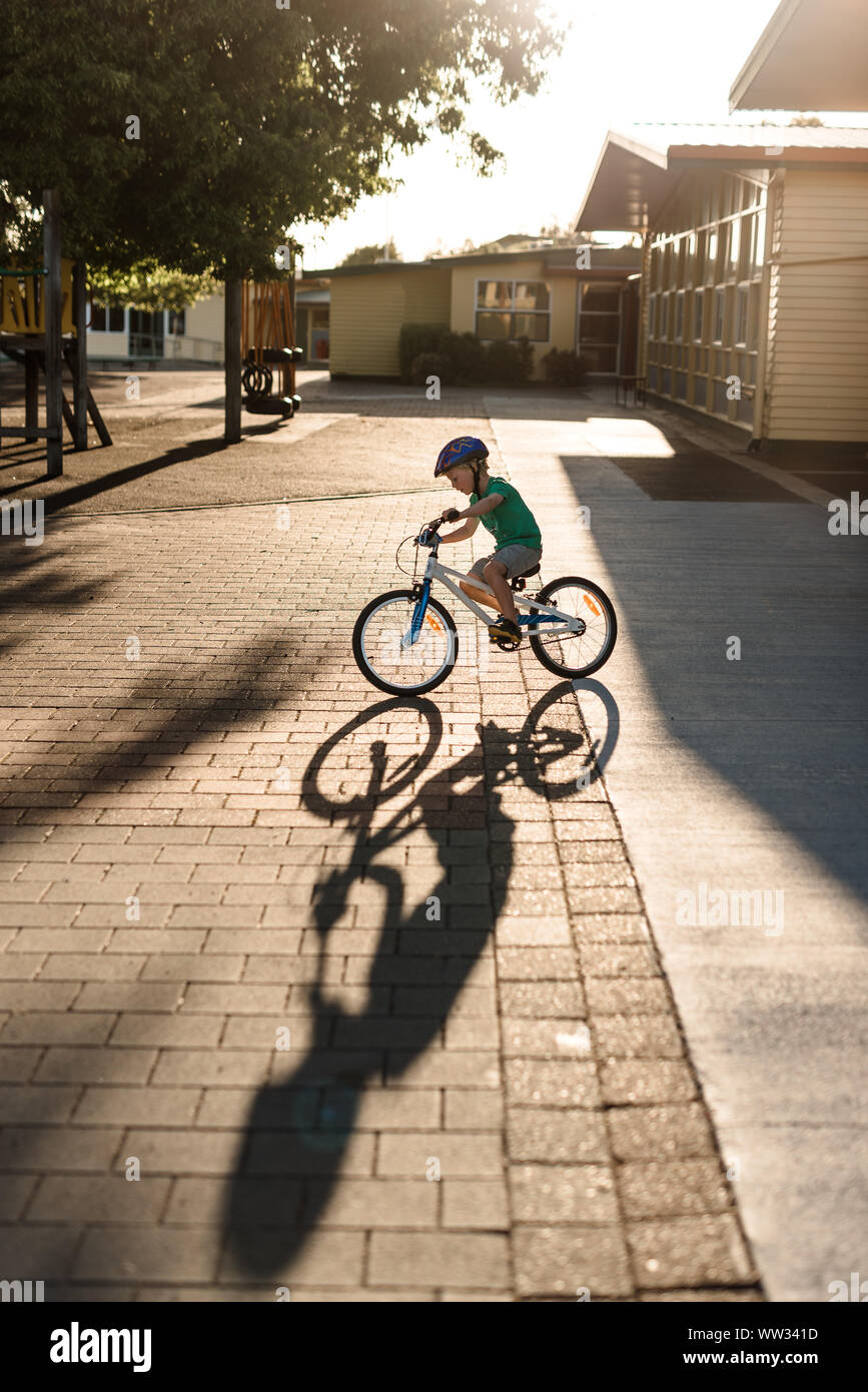 Child riding a bike to school hi-res stock photography and images - Alamy