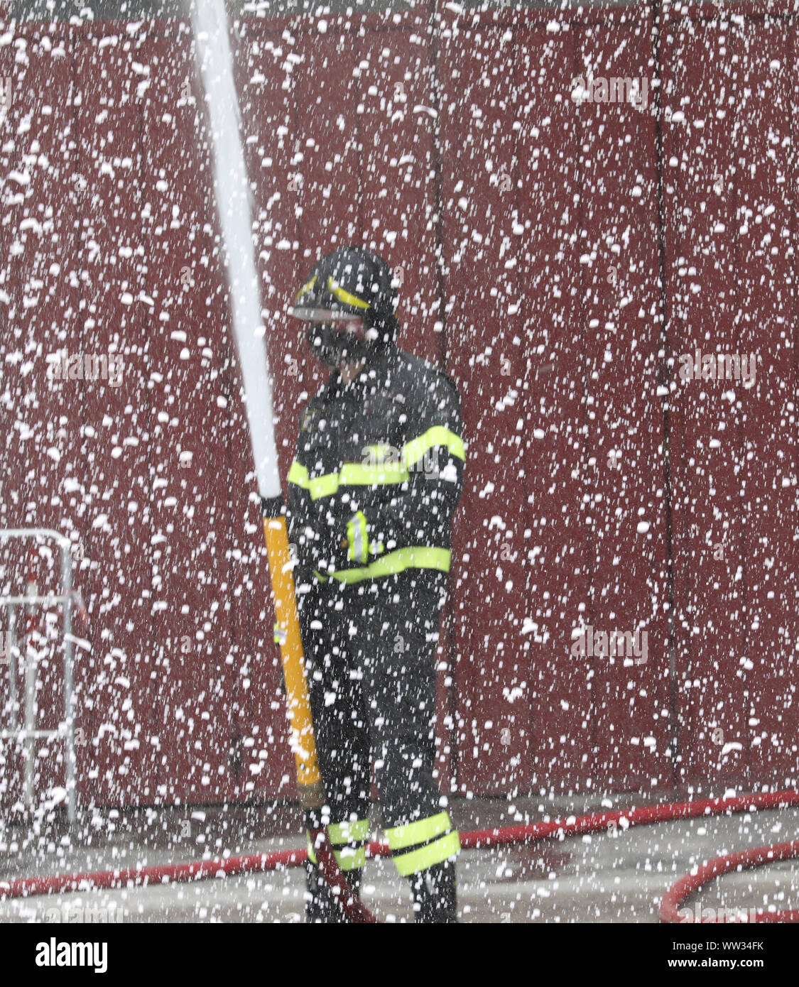 fire fighter uses foam like snow during fire Stock Photo - Alamy