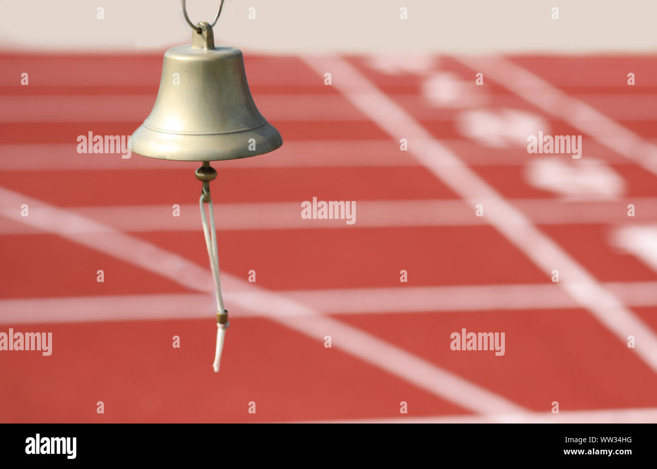 bronze bell in the athletics field that is played to signal the last ...