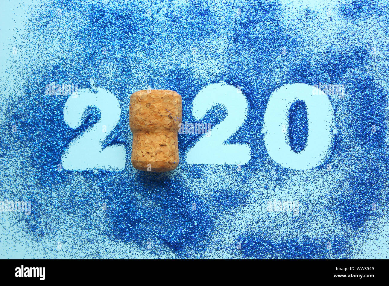 2020. The numbers 2020 and cork from champagne isolated on a blue ...